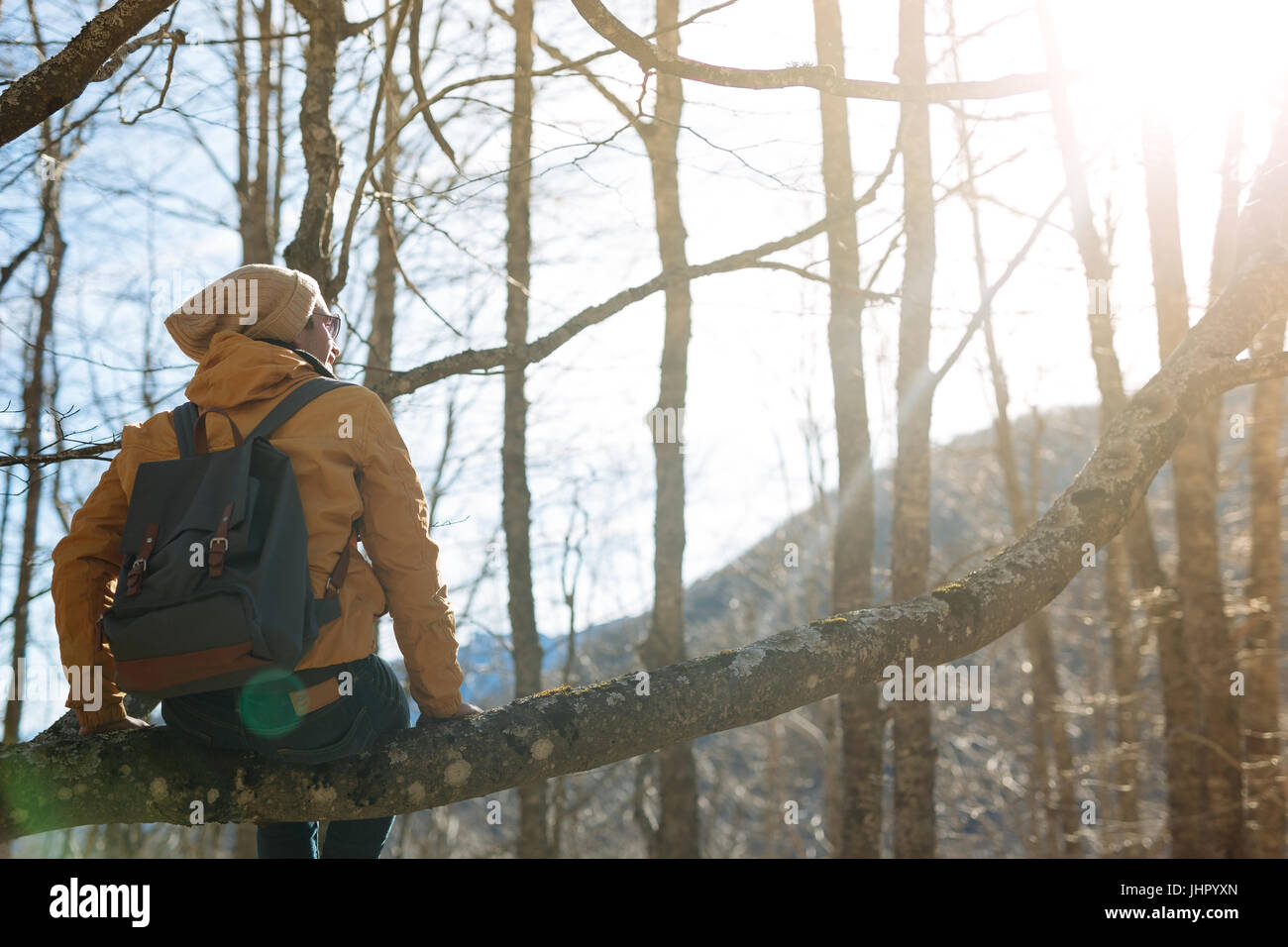 Young man standing in the forest and exploring, freedom and nature ...