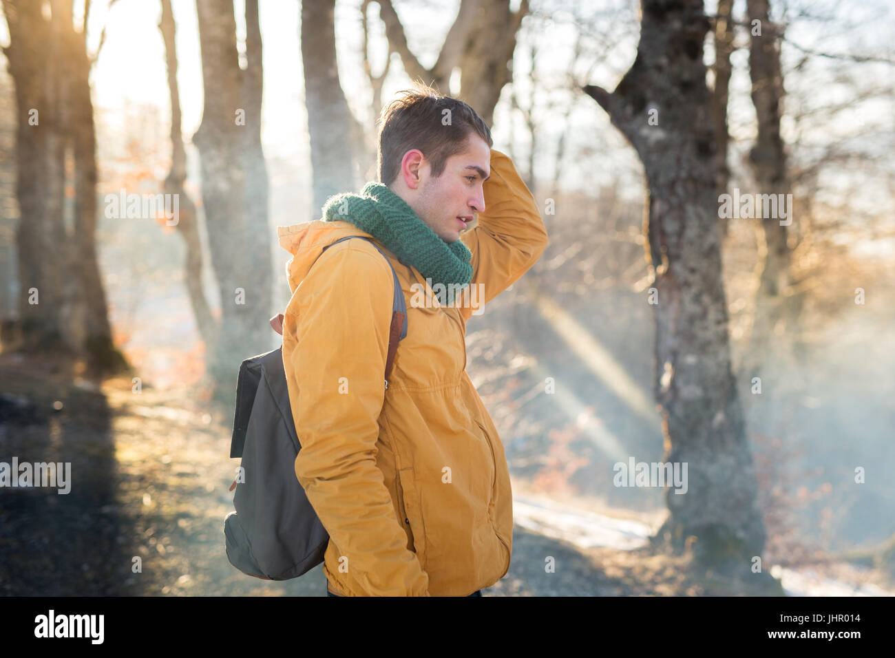 Young man standing in the forest and exploring, freedom and nature ...