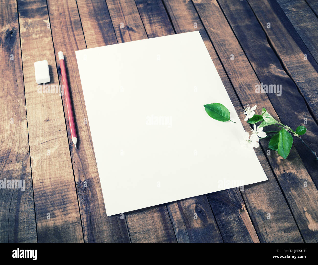 Blank letterhead, pencil, eraser, flowers and green leaves on vintage ...