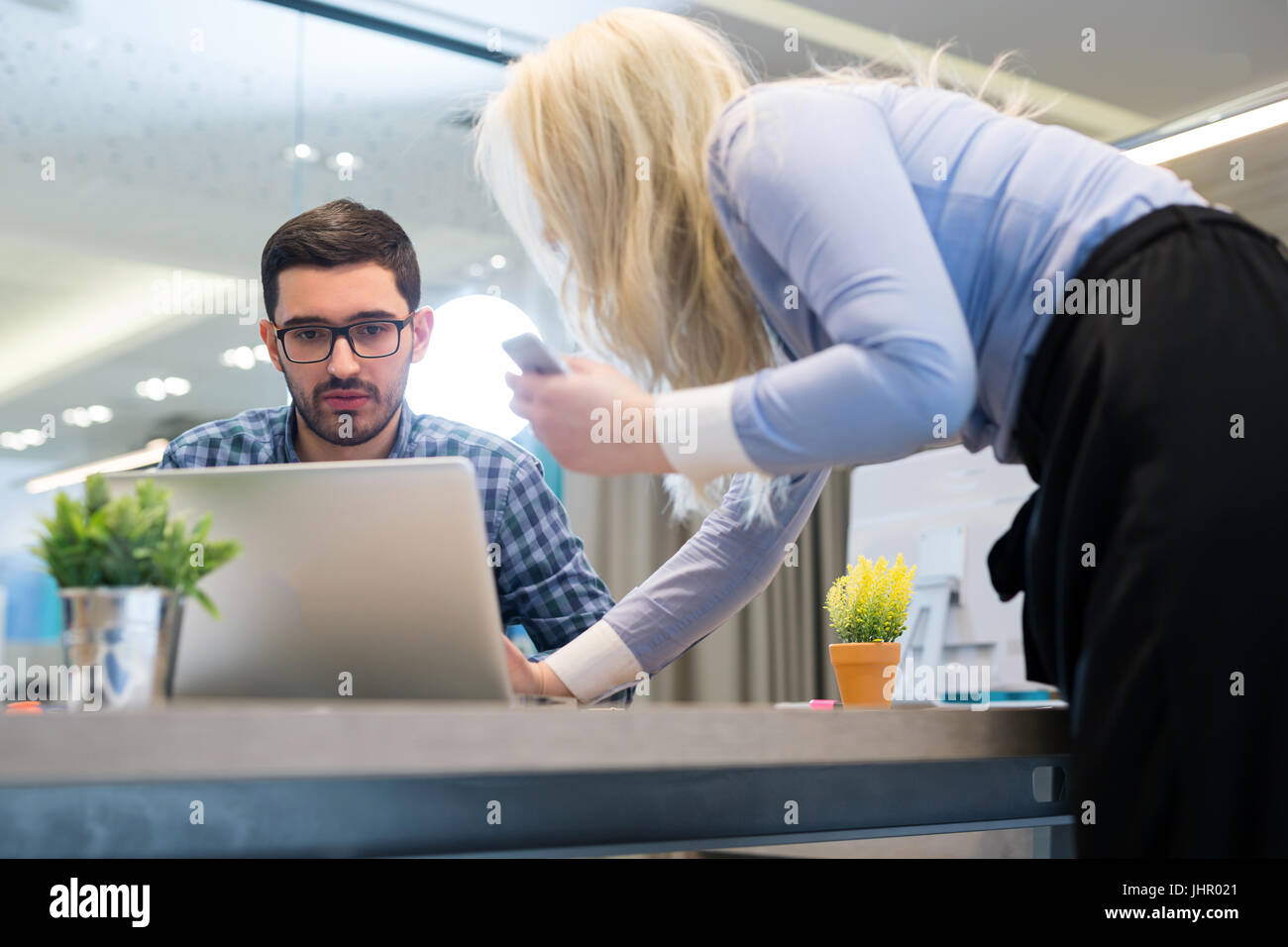 Office colleagues working together Stock Photo - Alamy