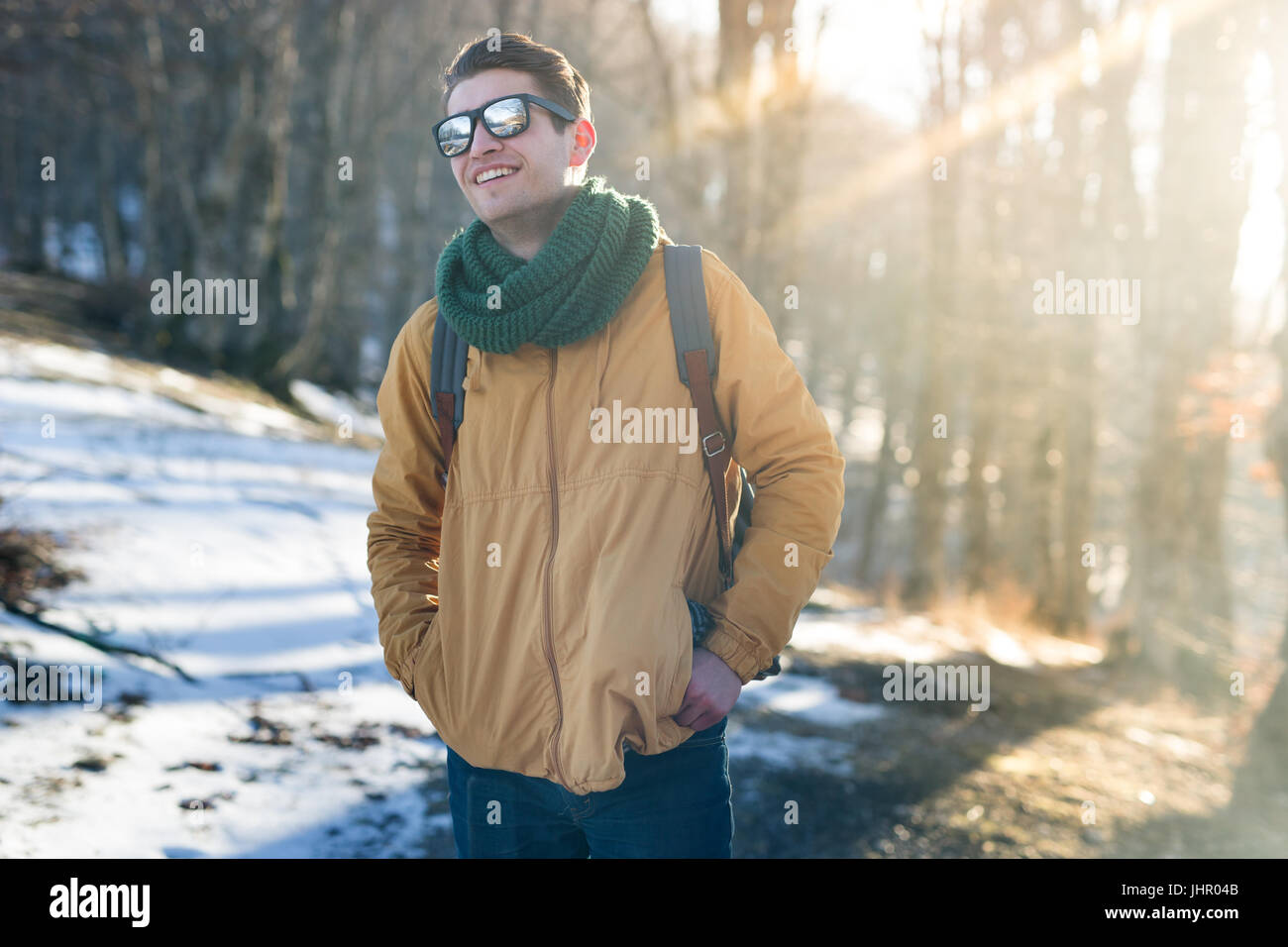 Young man standing in the forest and exploring, freedom and nature ...