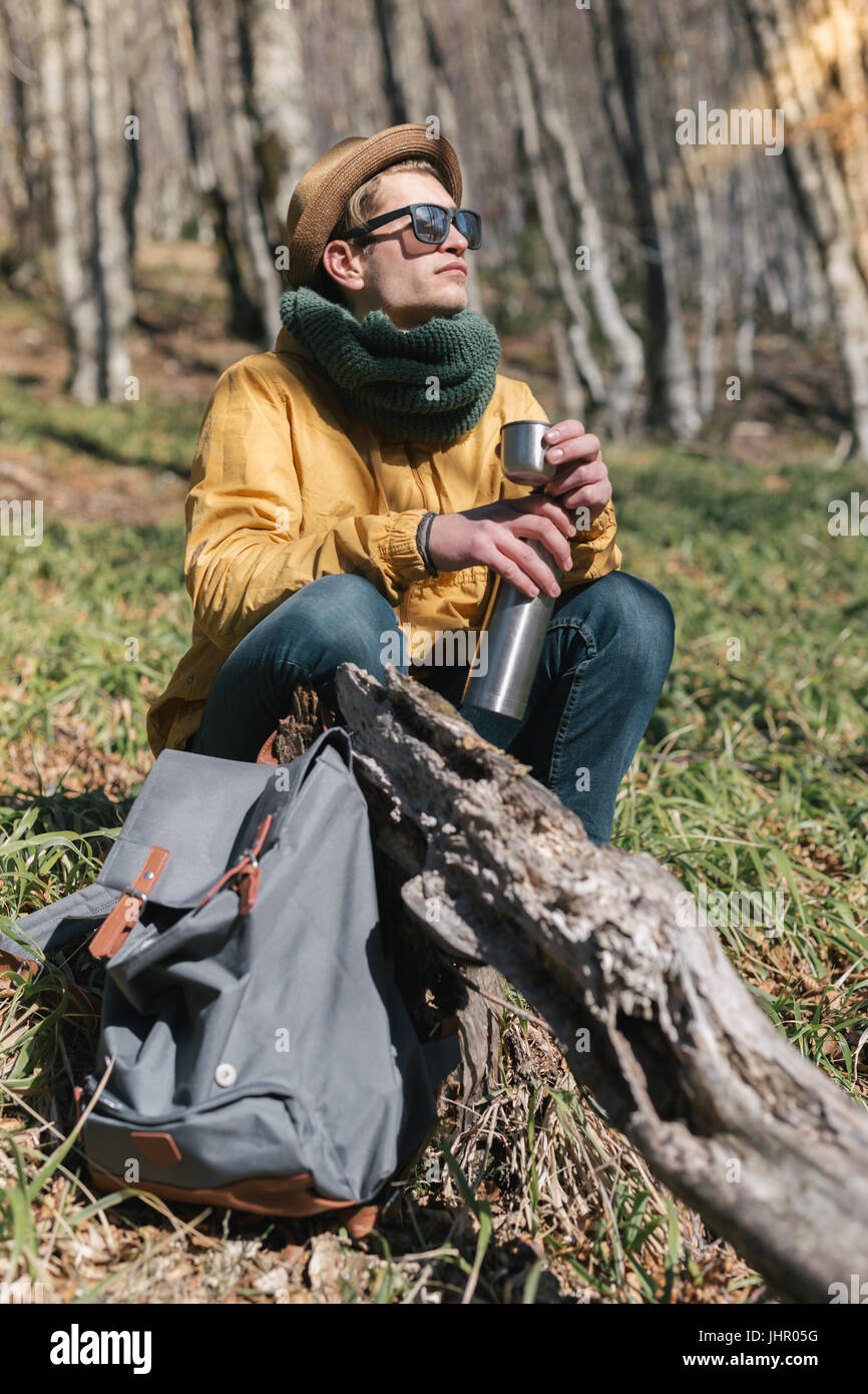 Young man standing in the forest and exploring, freedom and nature ...