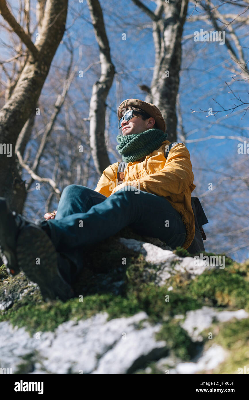 Young man standing in the forest and exploring, freedom and nature ...