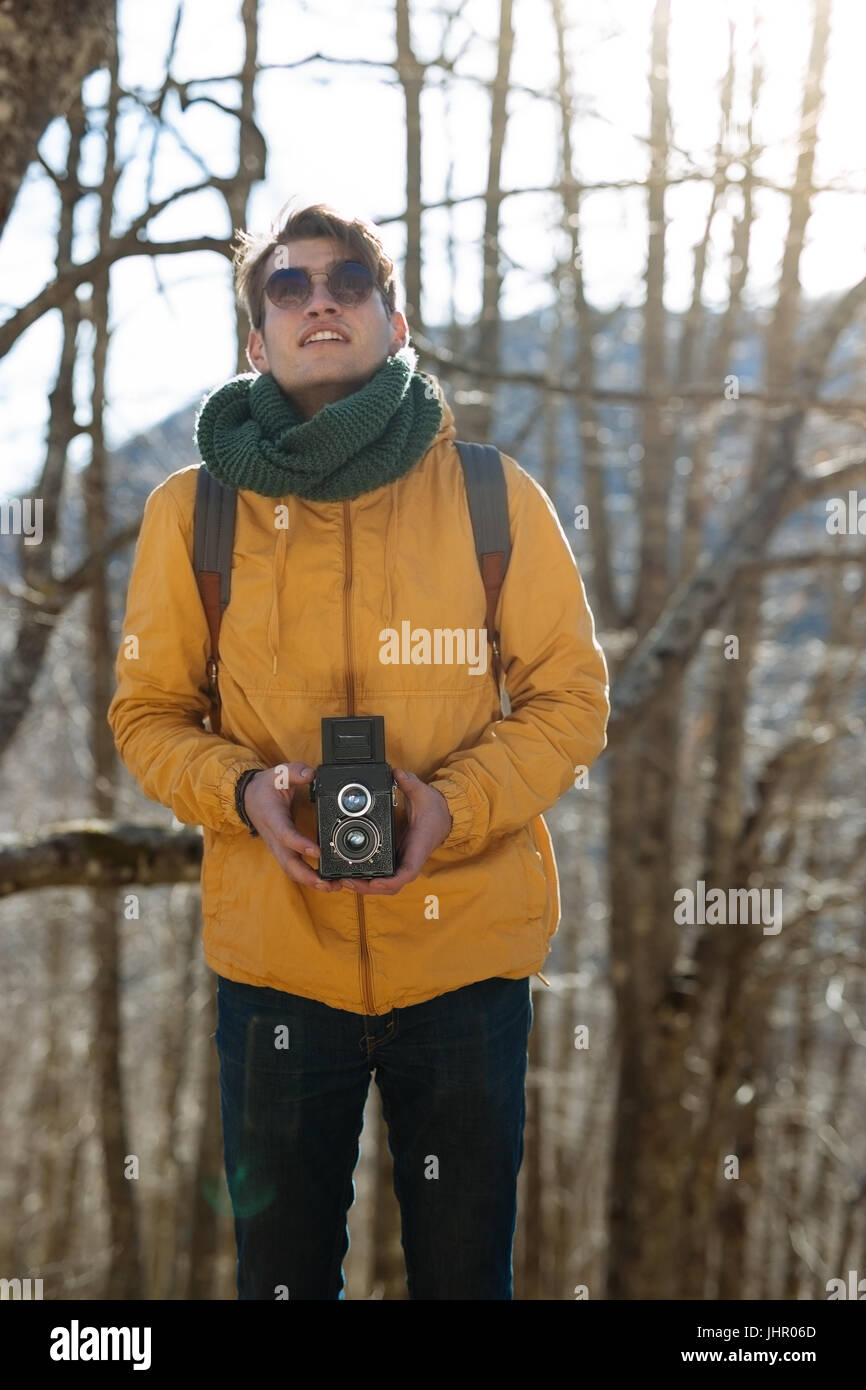 retro stylized photo of young man photographer with vintage camera ...
