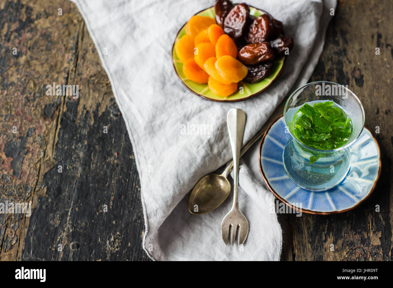 Eastern tea with mint and arabian sweets on wooden rustic table Stock ...