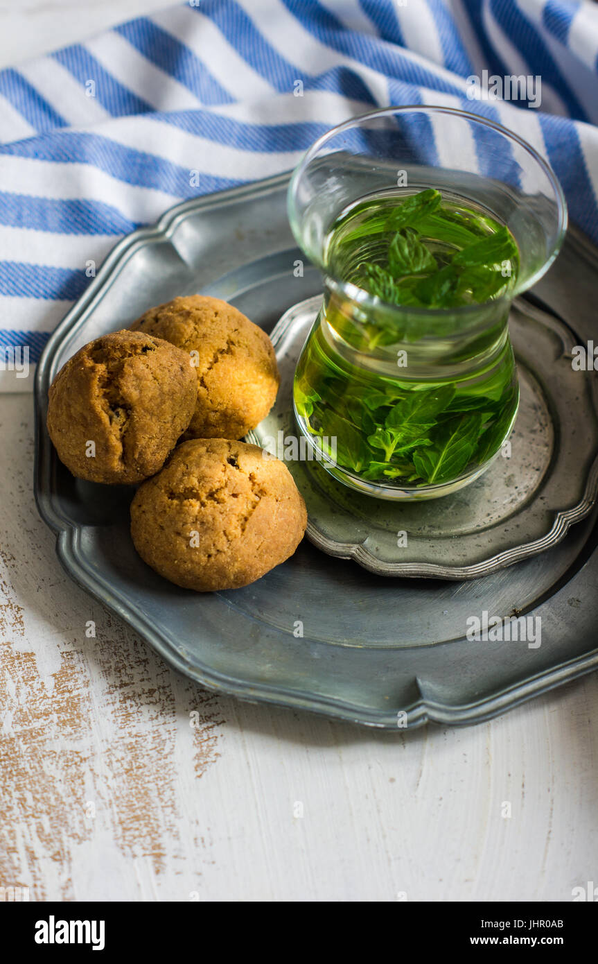 Eastern tea with mint and arabian sweets on wooden rustic table Stock ...