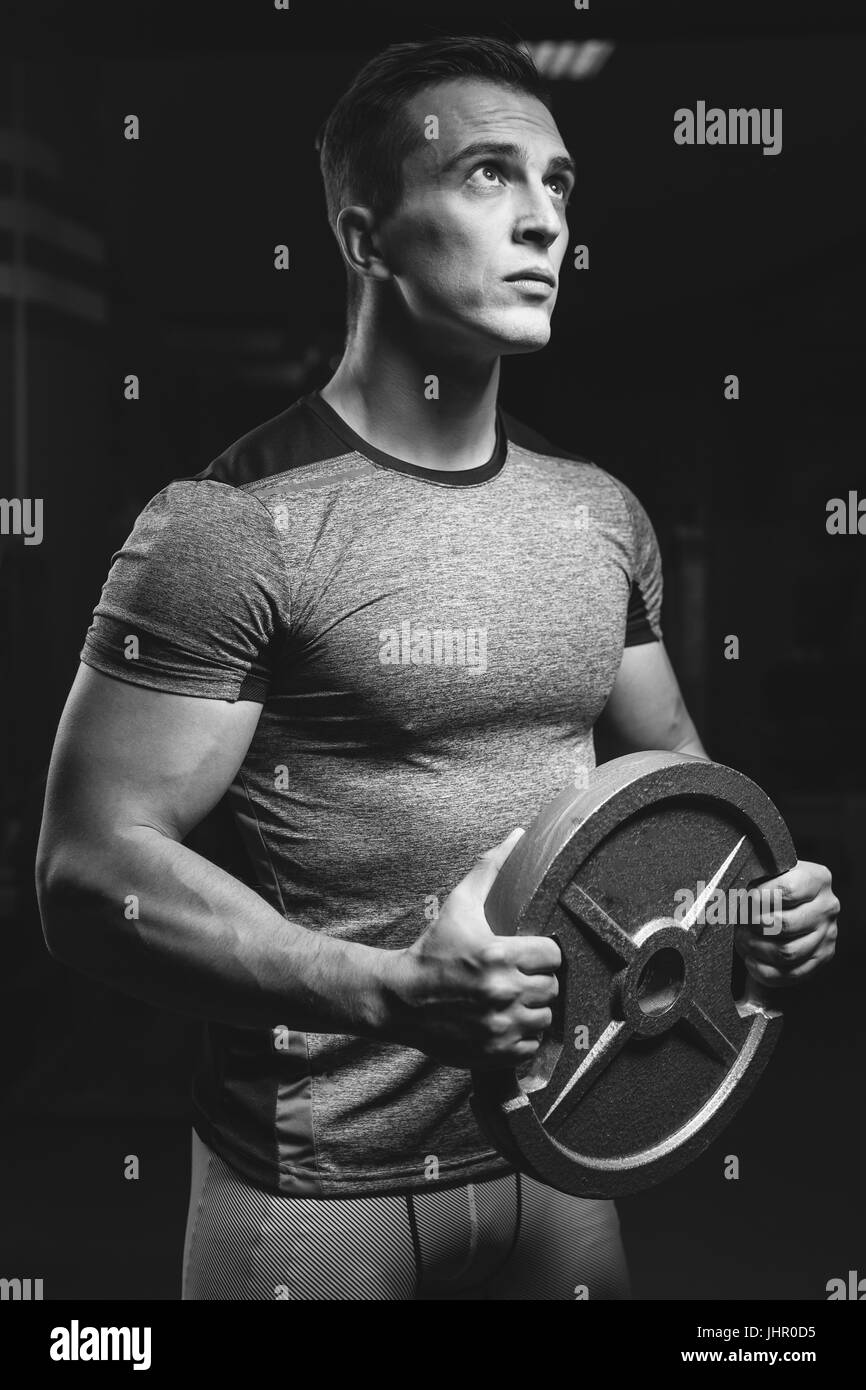 man with weight training equipment on sport gym club Stock Photo - Alamy
