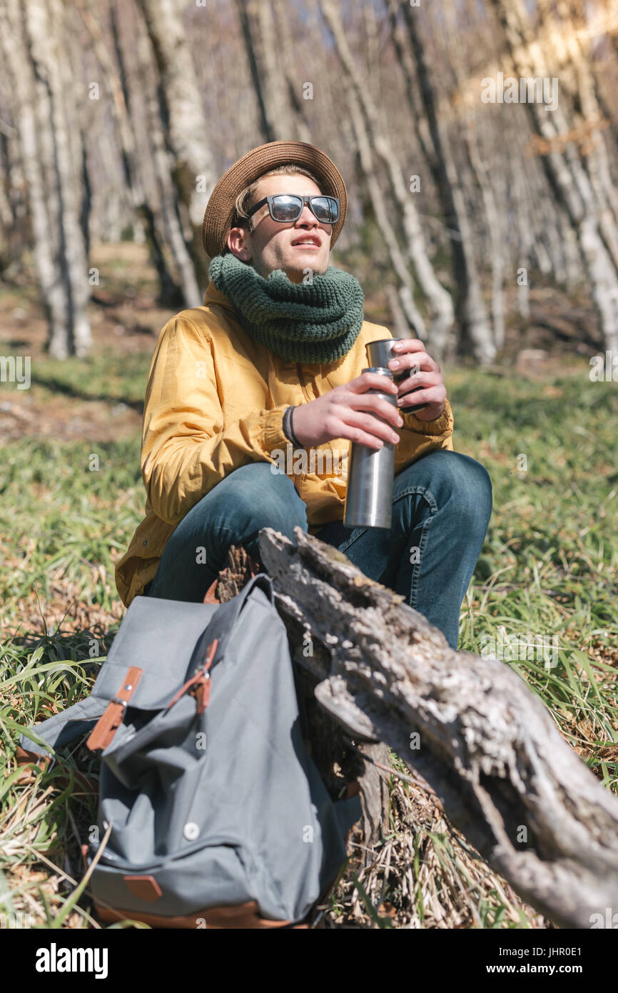 Young man standing in the forest and exploring, freedom and nature ...