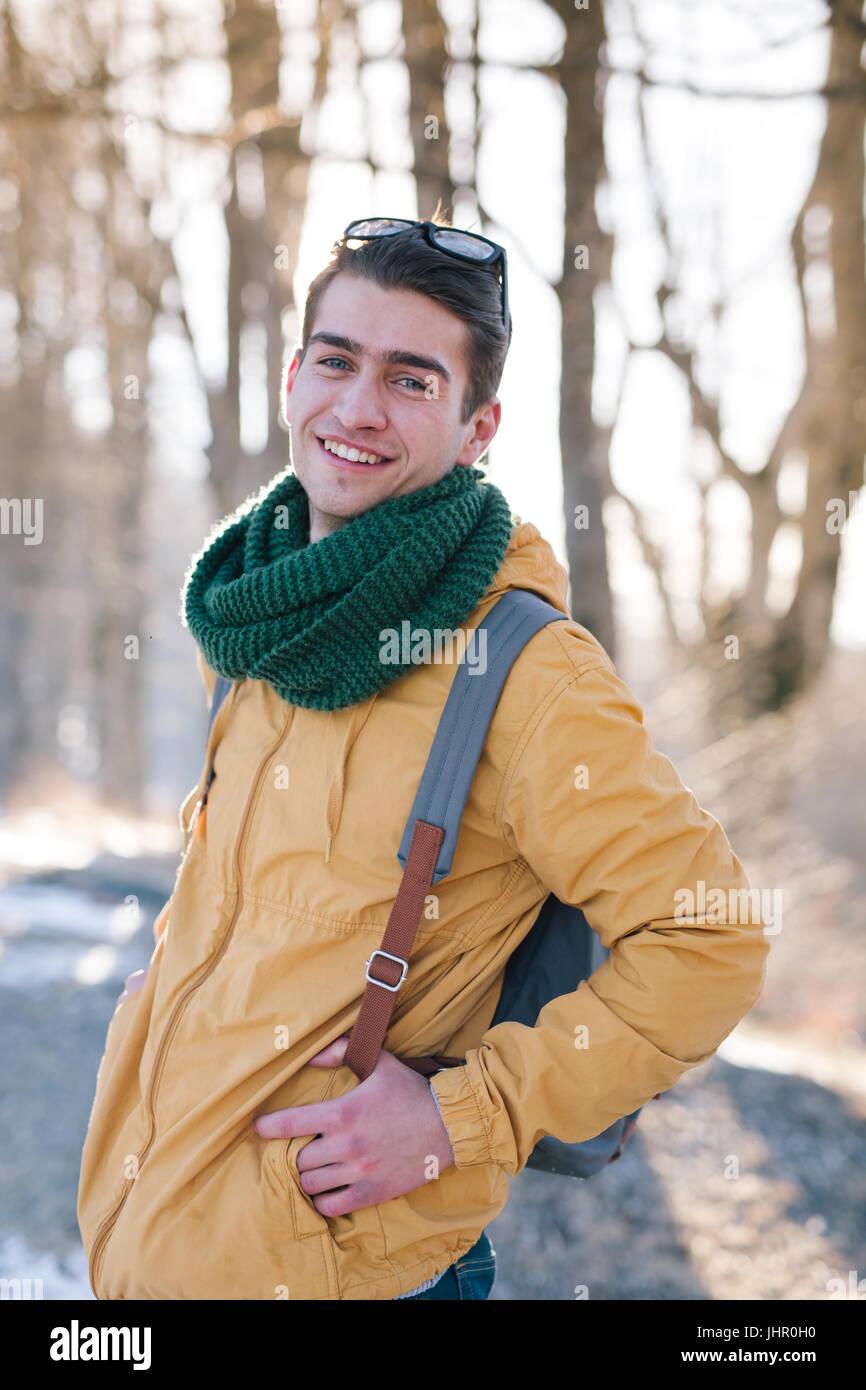Young man standing in the forest and exploring, freedom and nature ...