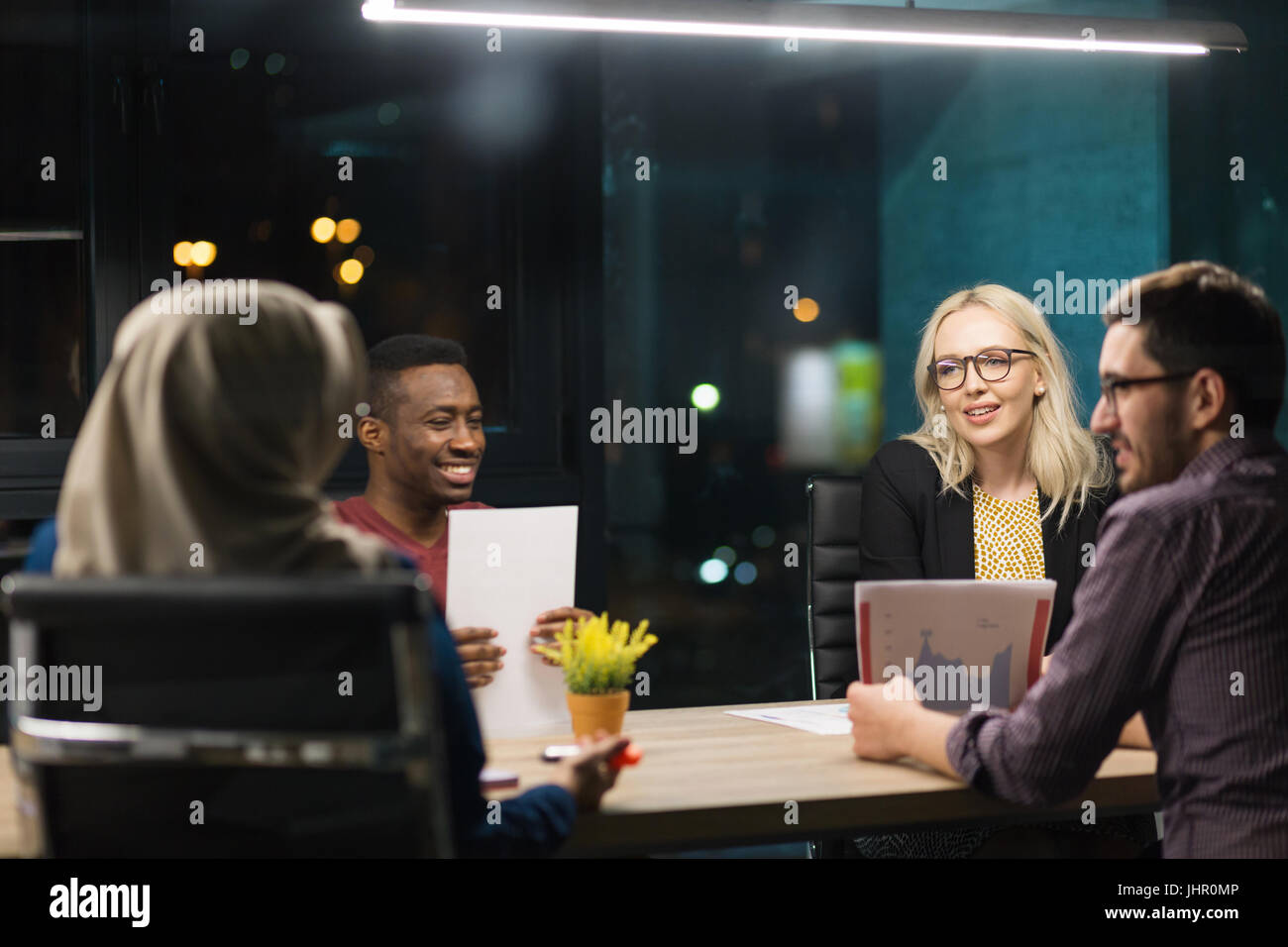 Colleagues working overtime in their office. Working a night shift in ...