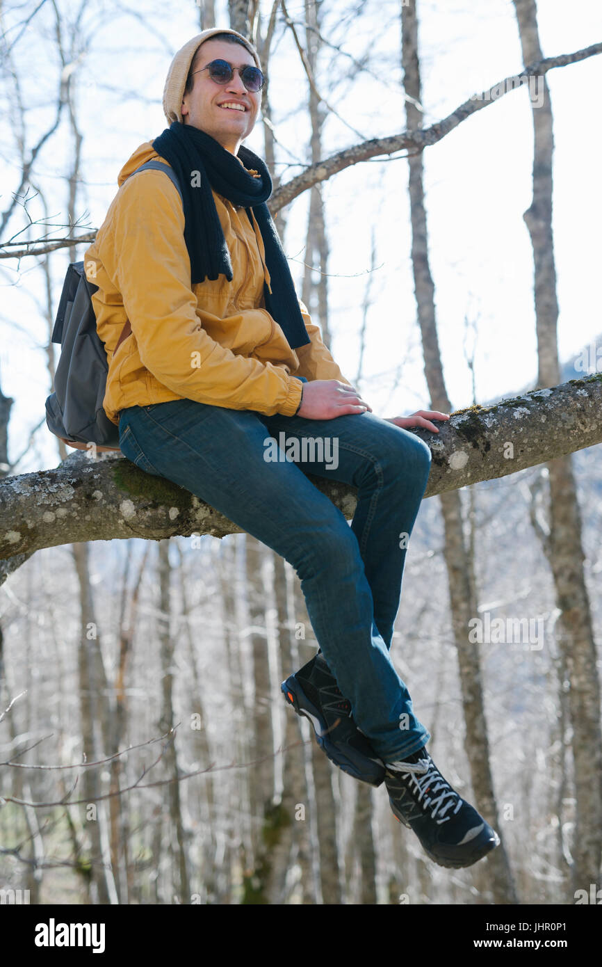 Young man standing in the forest and exploring, freedom and nature ...