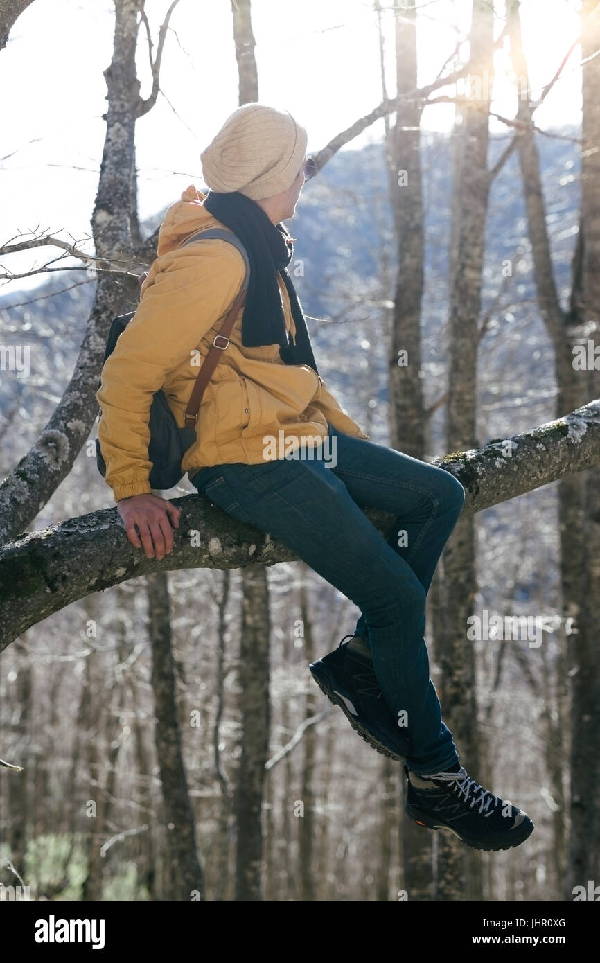Young man standing in the forest and exploring, freedom and nature ...
