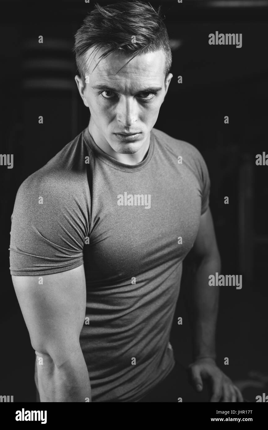 Strong man posing in dark Black and White Stock Photos & Images - Alamy