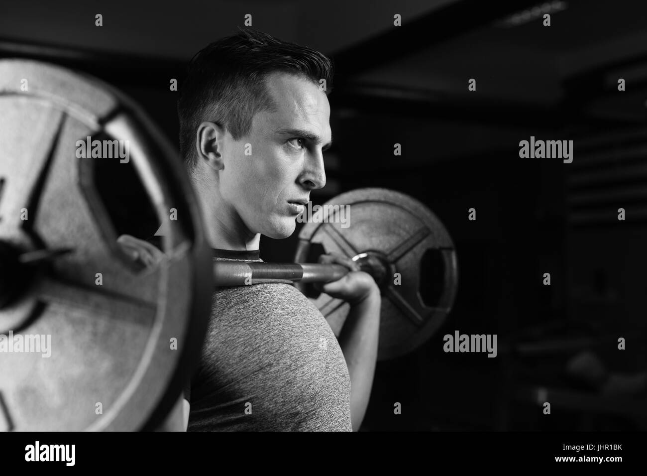 man with weight training equipment on sport gym club Stock Photo - Alamy