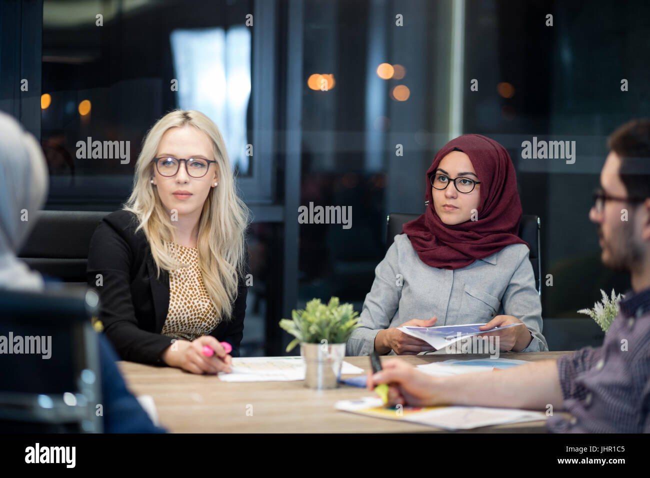 Colleagues working overtime in their office. Working a night shift in ...