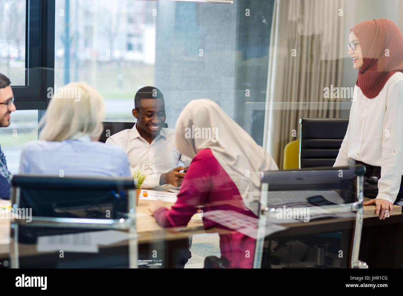 Back view of co-workers writing documents using laptops at workplace in ...