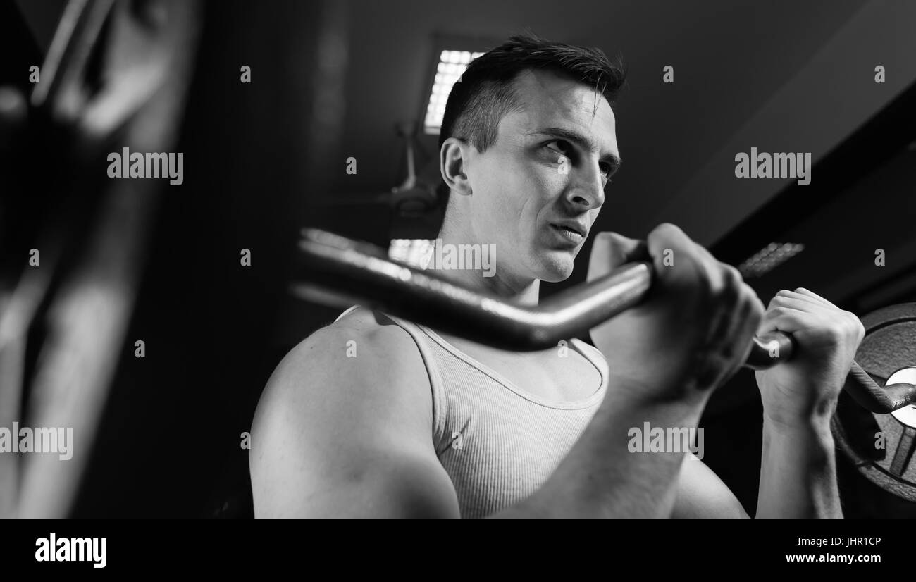 man with weight training equipment on sport gym club Stock Photo - Alamy