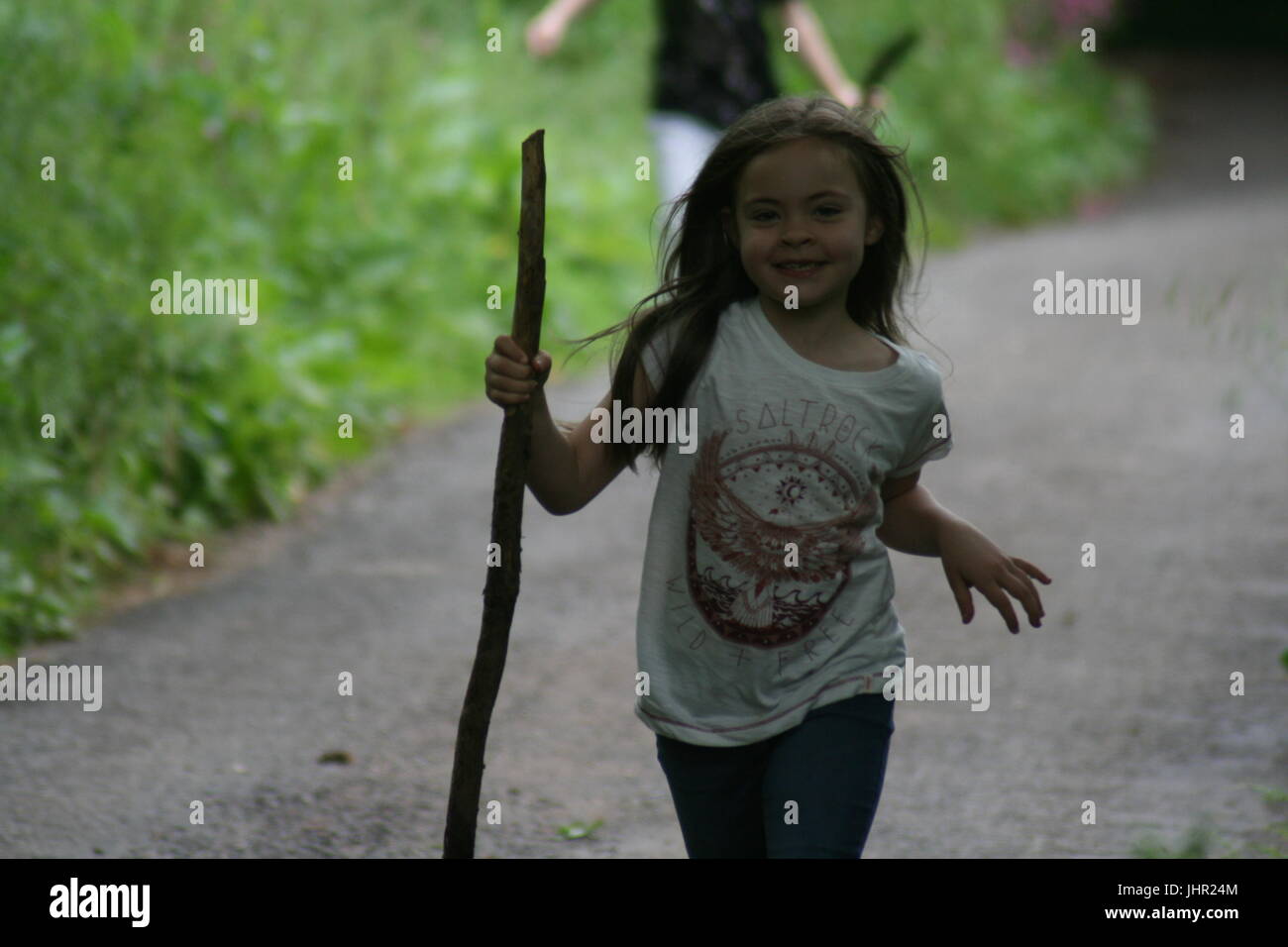 Girl with a stick Stock Photo - Alamy