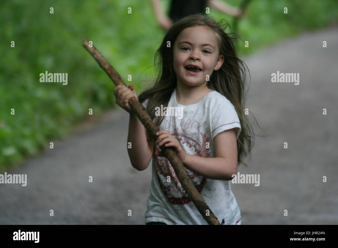Girl with a stick Stock Photo - Alamy