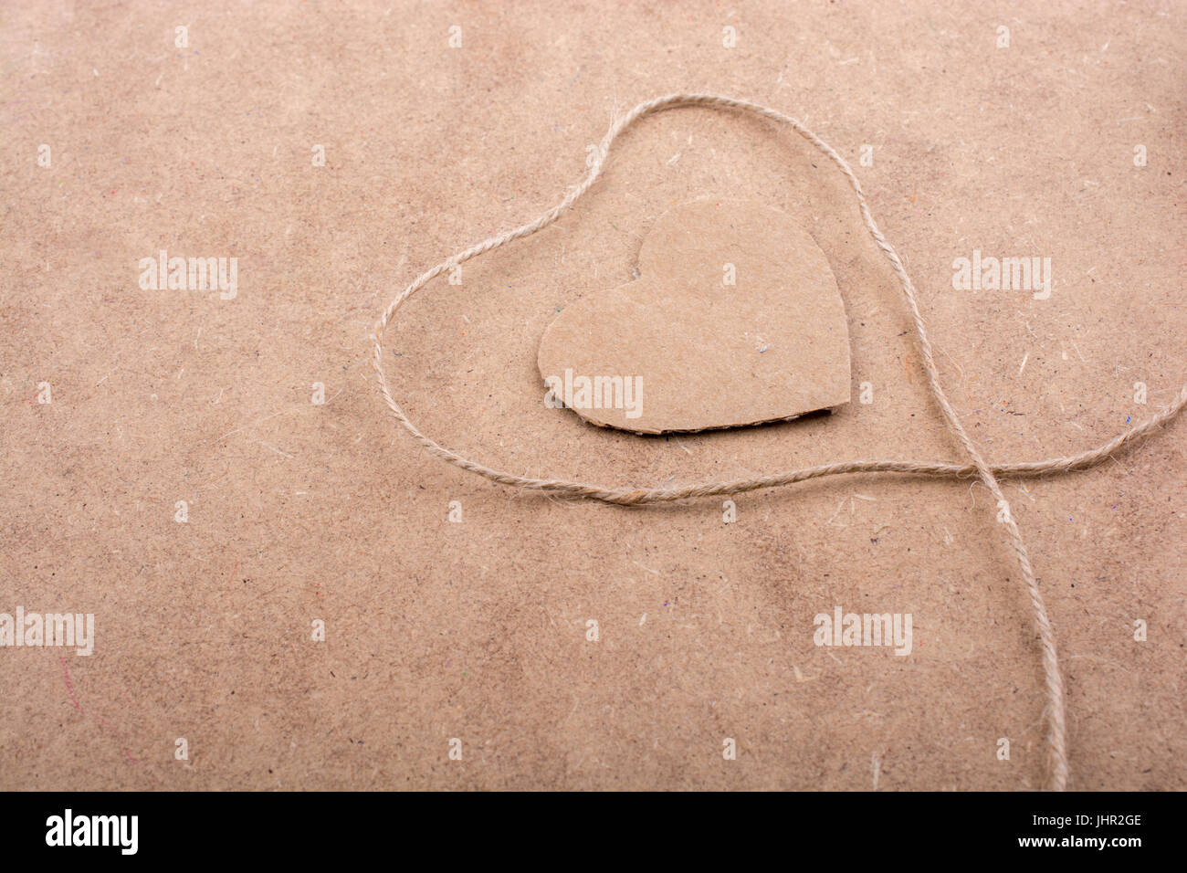 Thread off spool form a heart shape on brown background Stock Photo - Alamy
