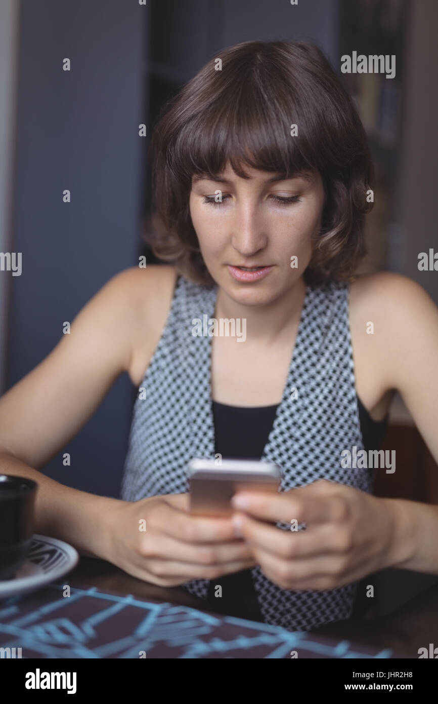 Woman using mobile phone in living room at home Stock Photo - Alamy