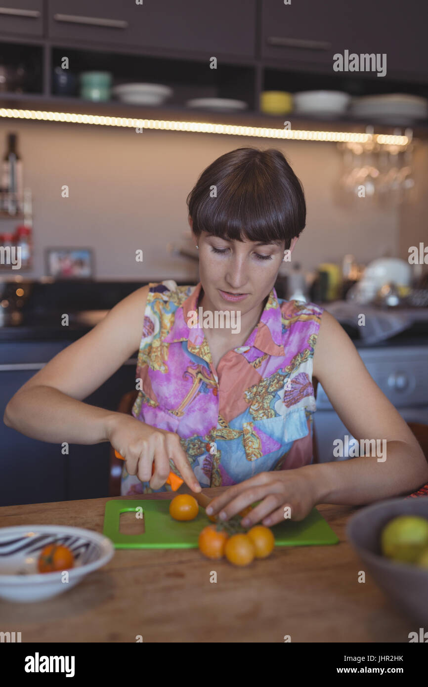 Woman chopping vegetables in kitchen at home Stock Photo - Alamy