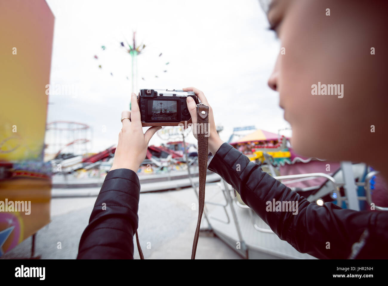 Woman clicking picture with digital camera in amusement park Stock ...