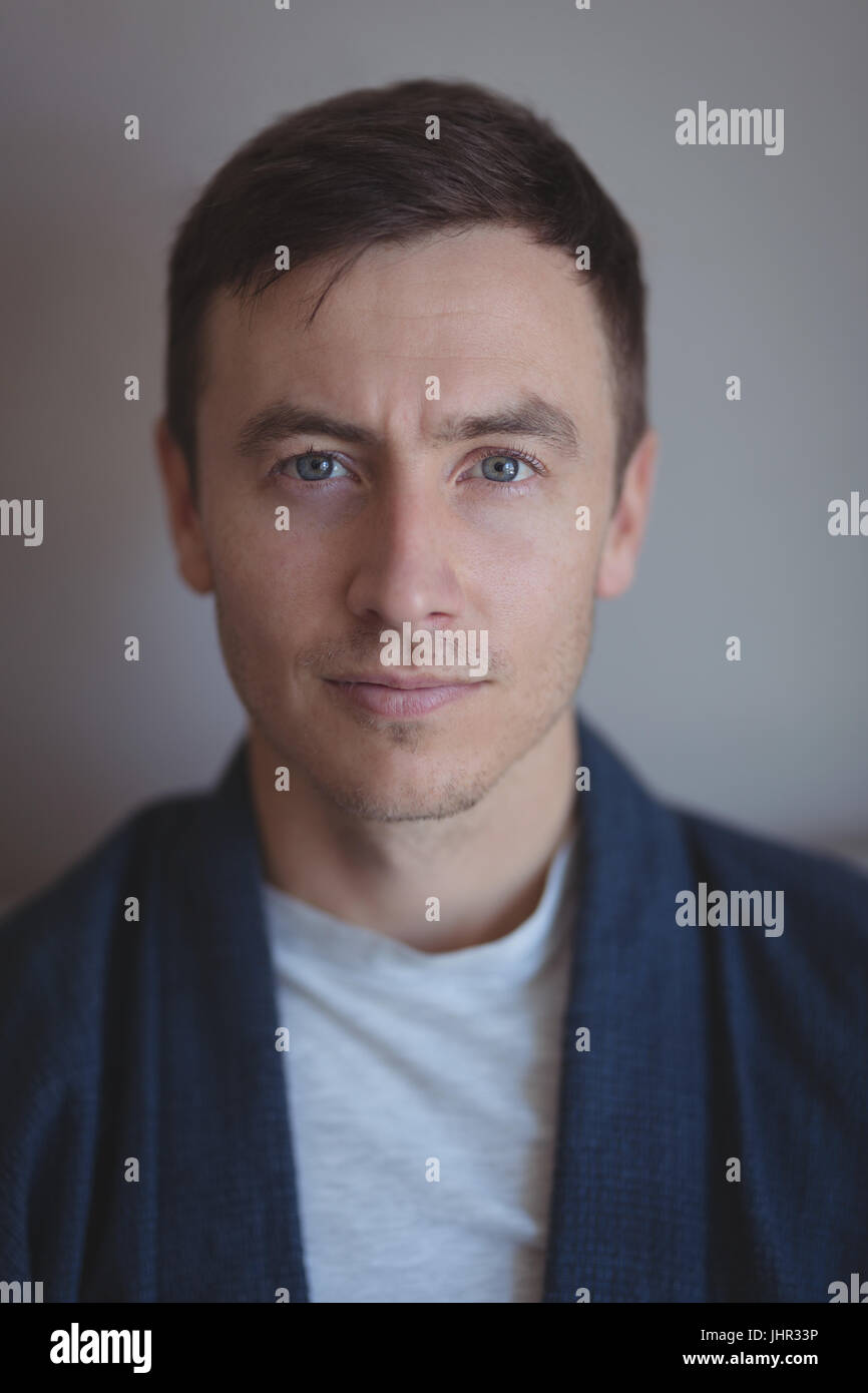 Portrait of man standing at home Stock Photo - Alamy