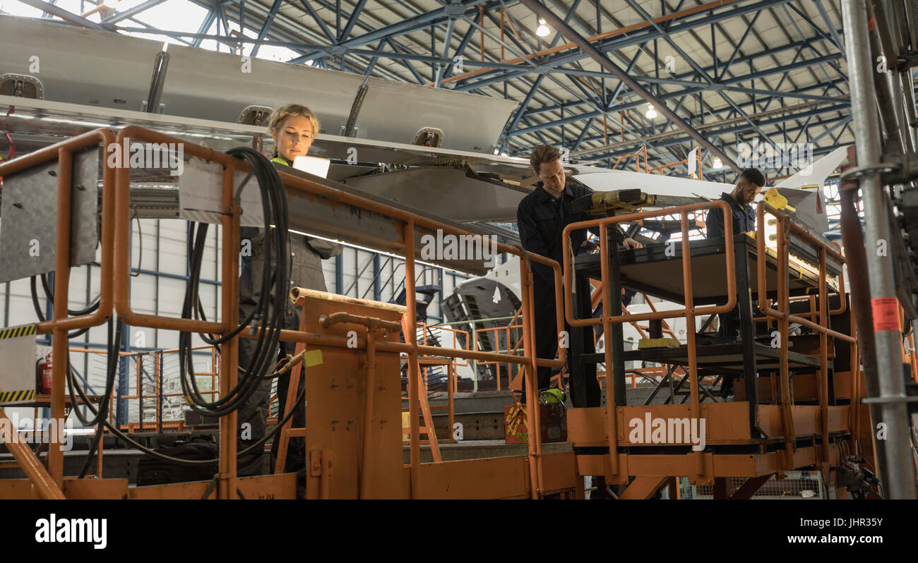 Aircraft maintenance engineers working on aircraft maintenance platform ...