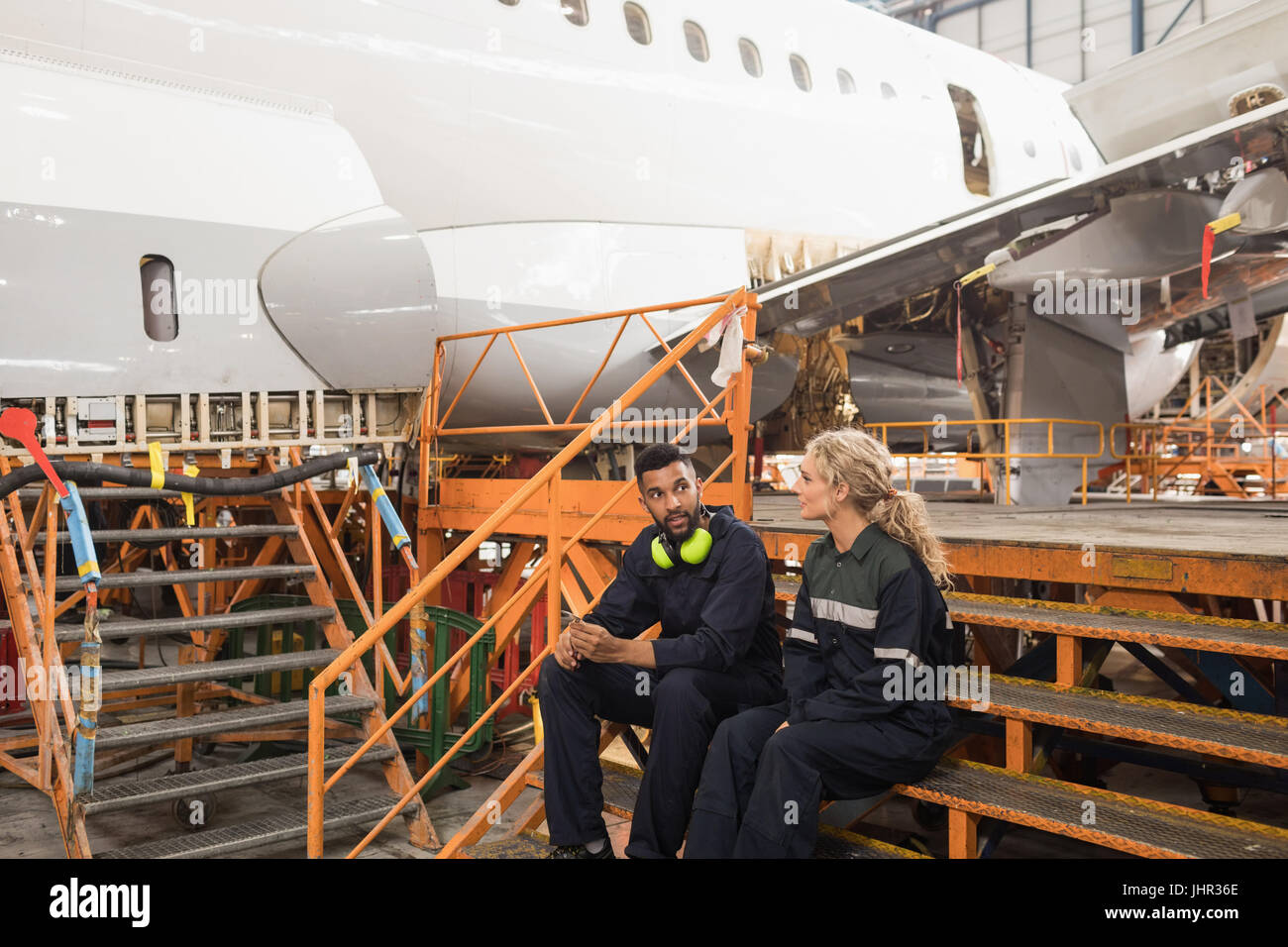 Aircraft maintenance engineers interacting with each other at airlines ...