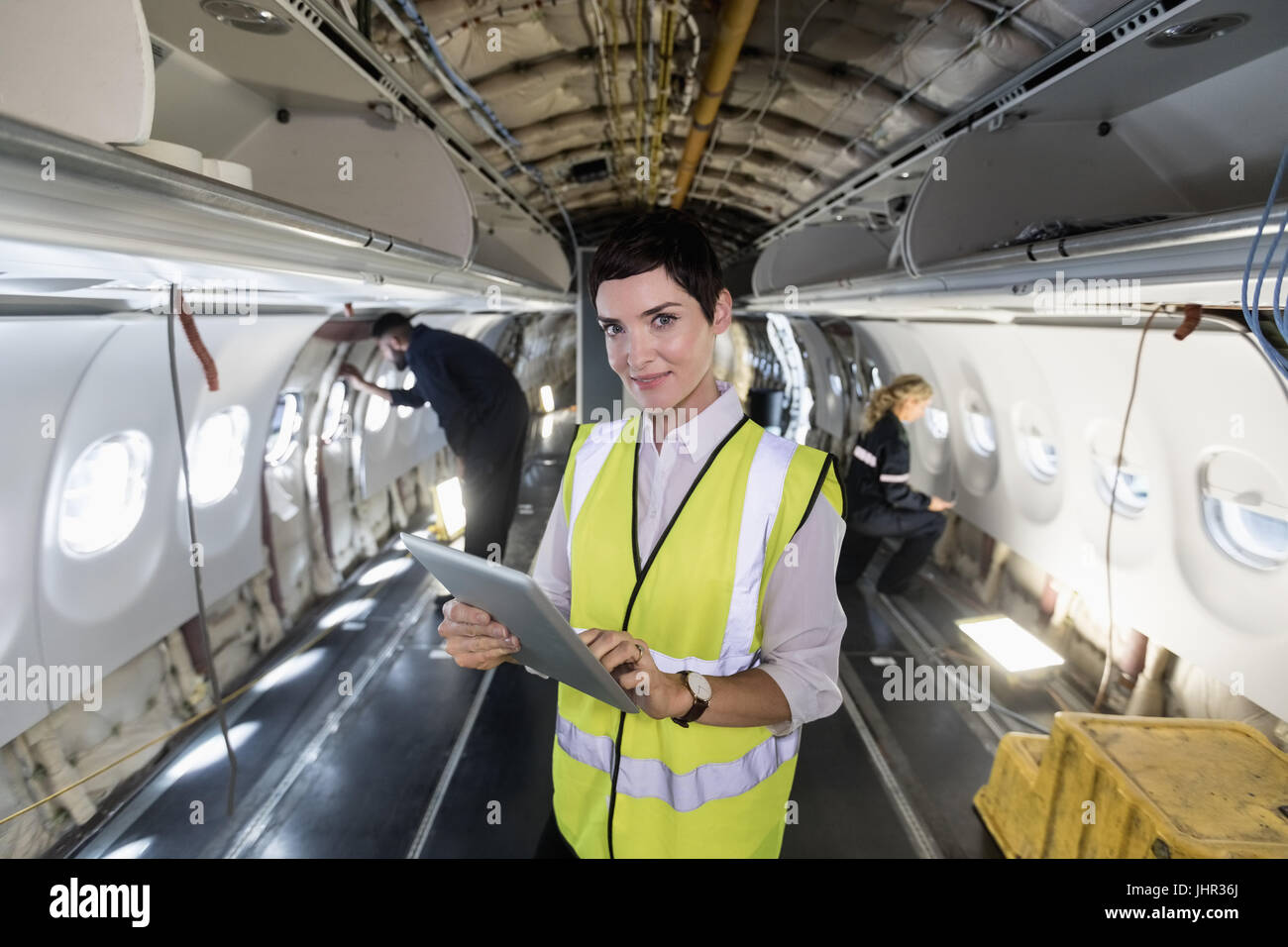 Aircraft maintenance engineers working over internal structure of an ...