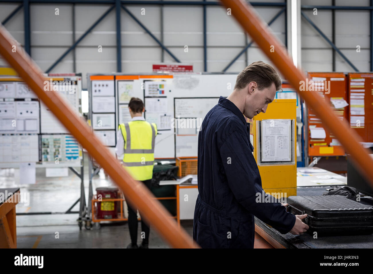Attentive maintenance engineers working at airlines maintenance ...