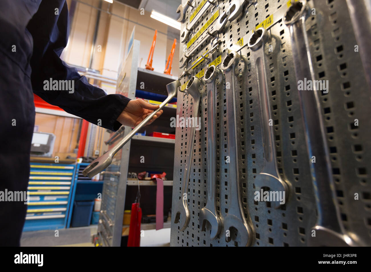 Male aircraft maintenance engineer examining various work tool at ...