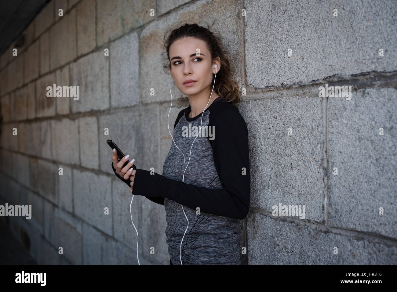 Fit woman relaxing in basement Stock Photo - Alamy