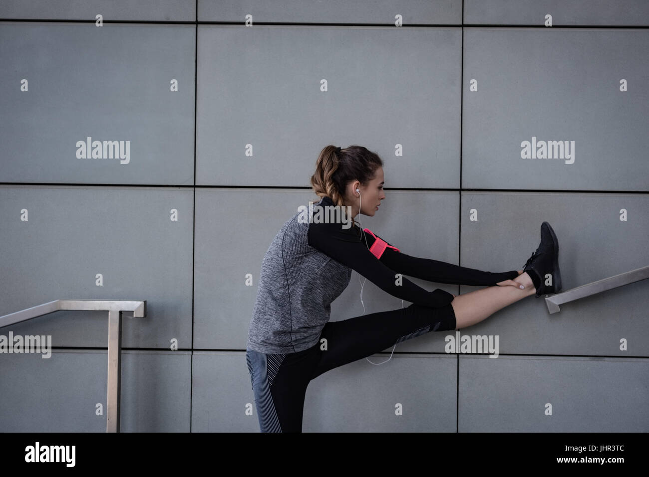 Fit woman performing stretching exercise on steps Stock Photo - Alamy