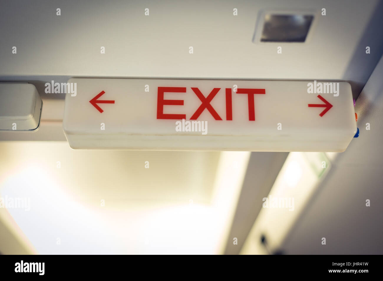 Close-up of exit sign board in aircraft Stock Photo - Alamy
