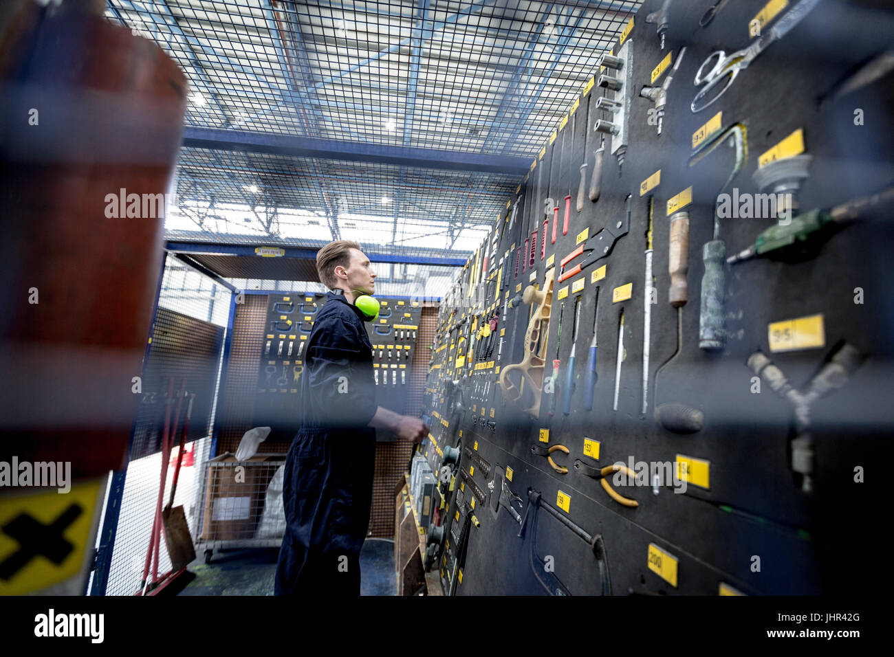 Male aircraft maintenance engineer examining various work tool at ...