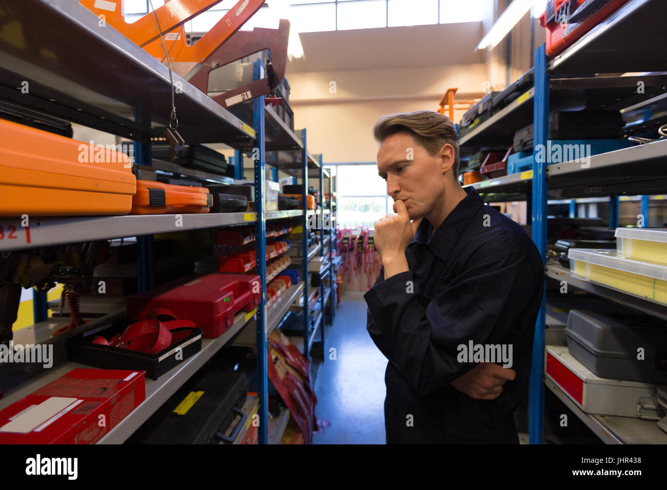 Male aircraft maintenance engineer examining various work tool at ...