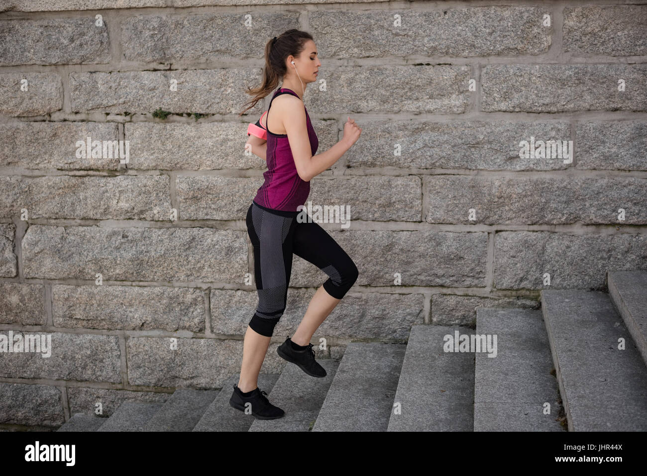 Fit woman jogging on steps Stock Photo - Alamy