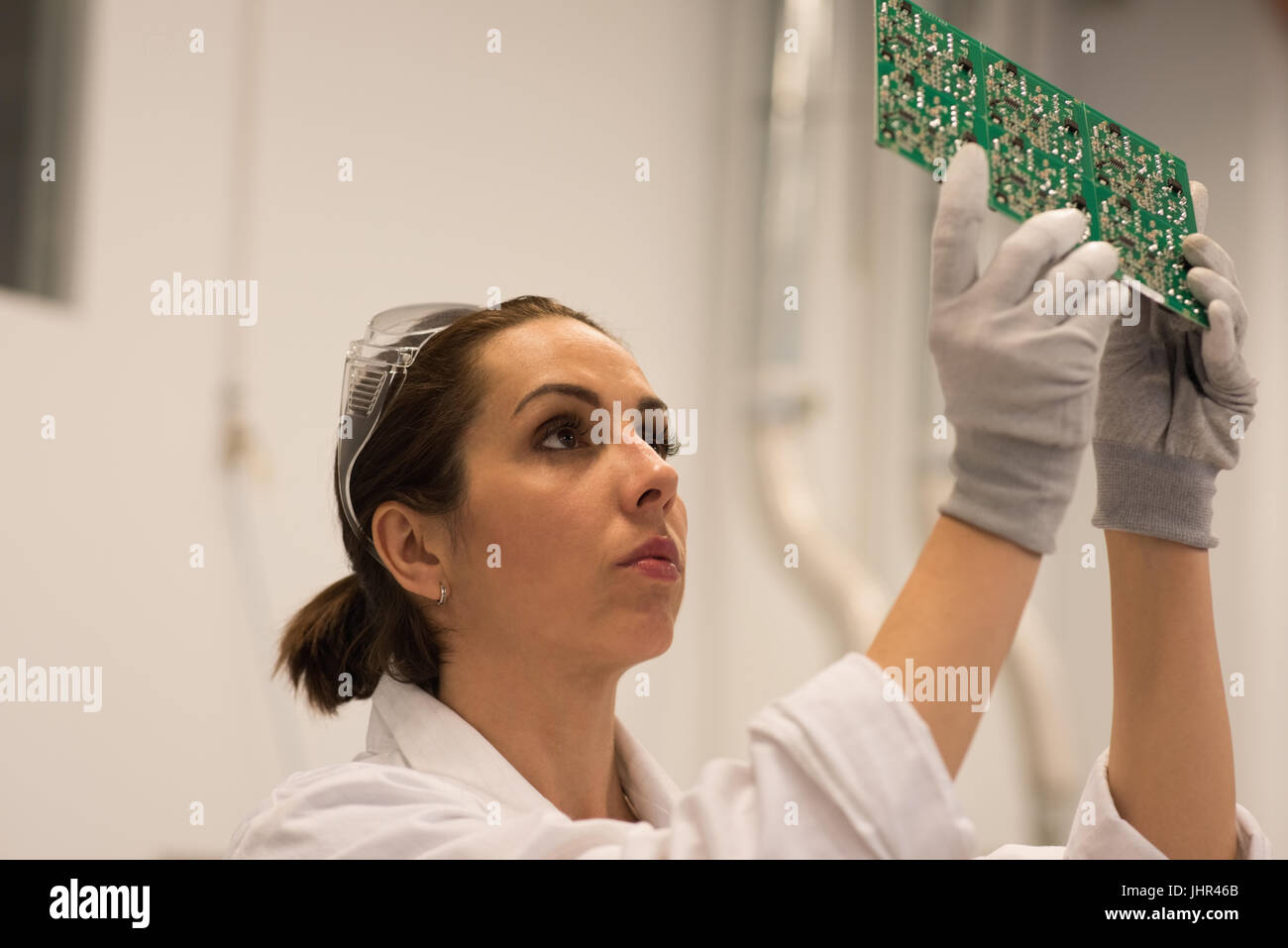 Female technician working on machine part at laboratory Stock Photo - Alamy