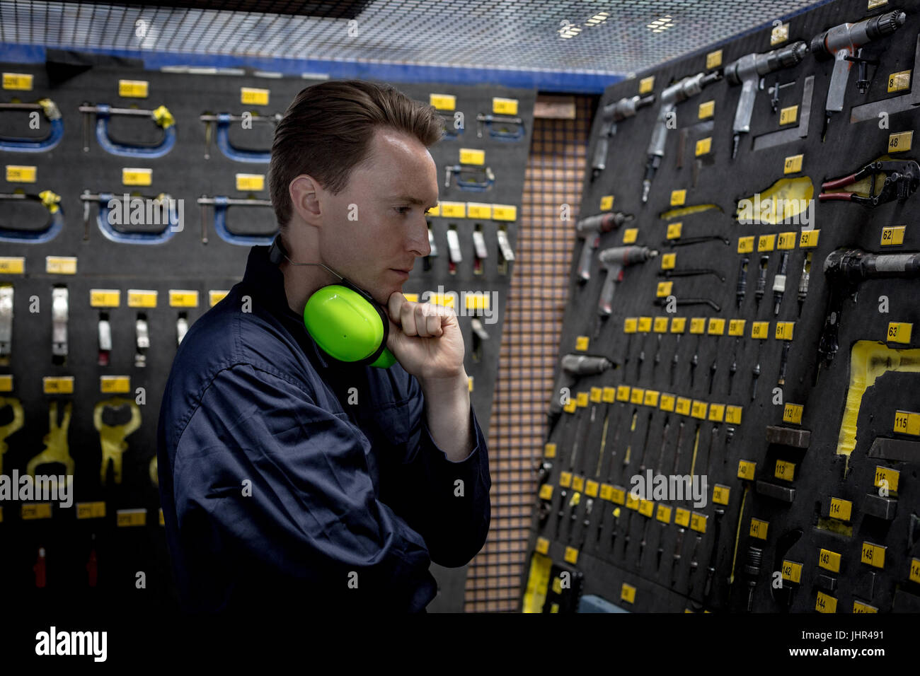 Male aircraft maintenance engineer examining various work tool Stock ...