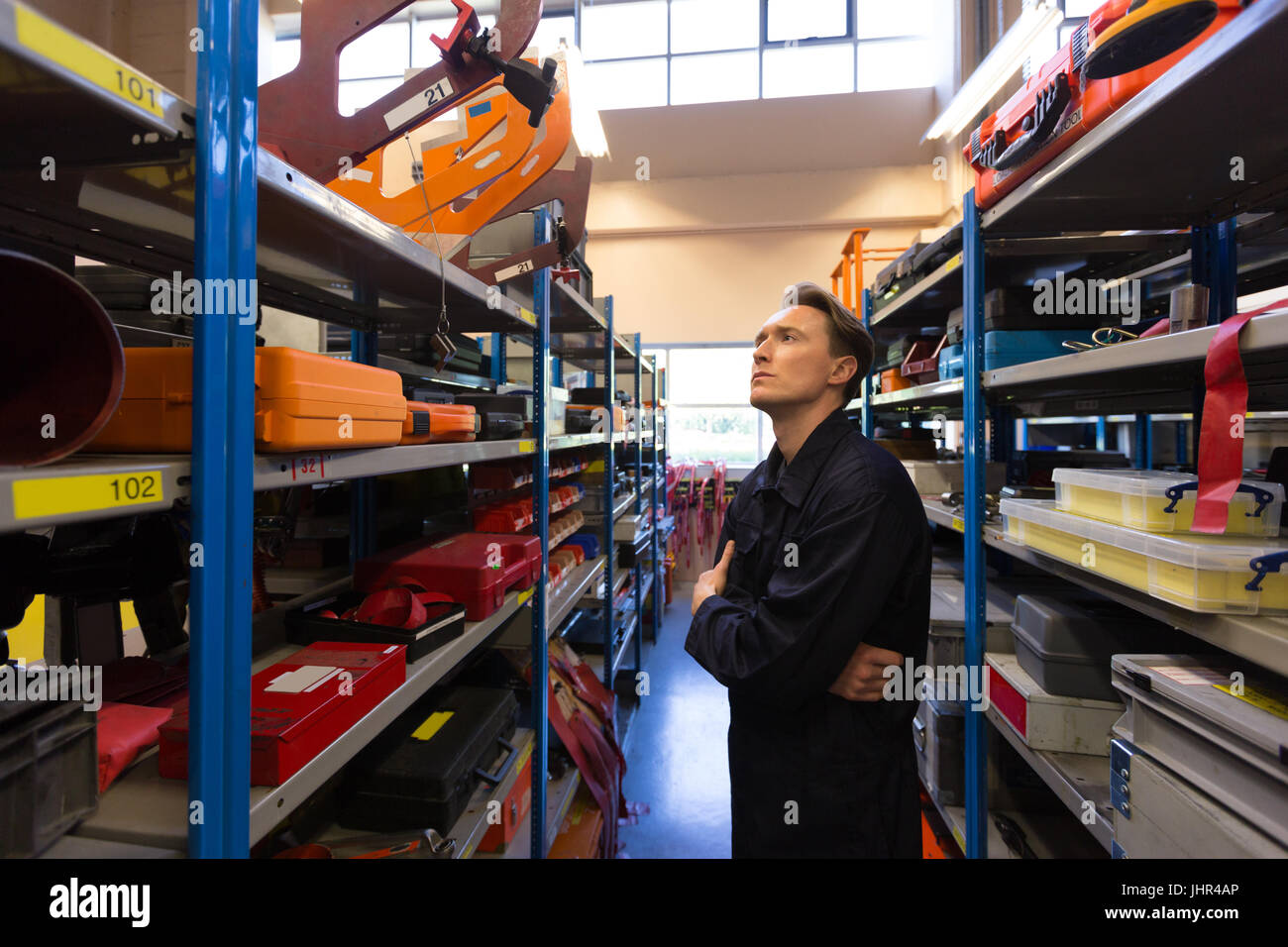 Male aircraft maintenance engineer examining various work tool at ...