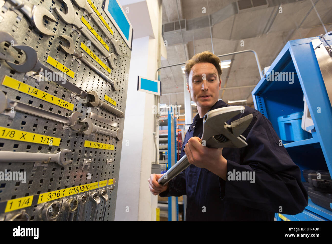 Male aircraft maintenance engineer examining various work tool at ...