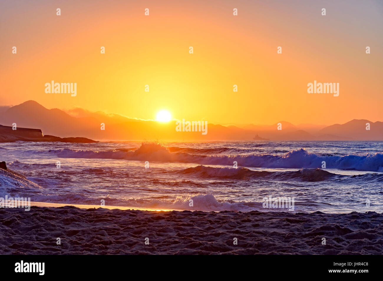 Tropical sunrise at Devil beach with Copacabana Fort in the background ...