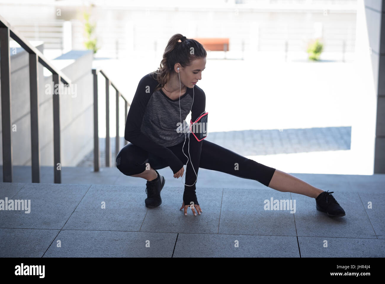 Fit woman performing stretching exercise on steps Stock Photo - Alamy