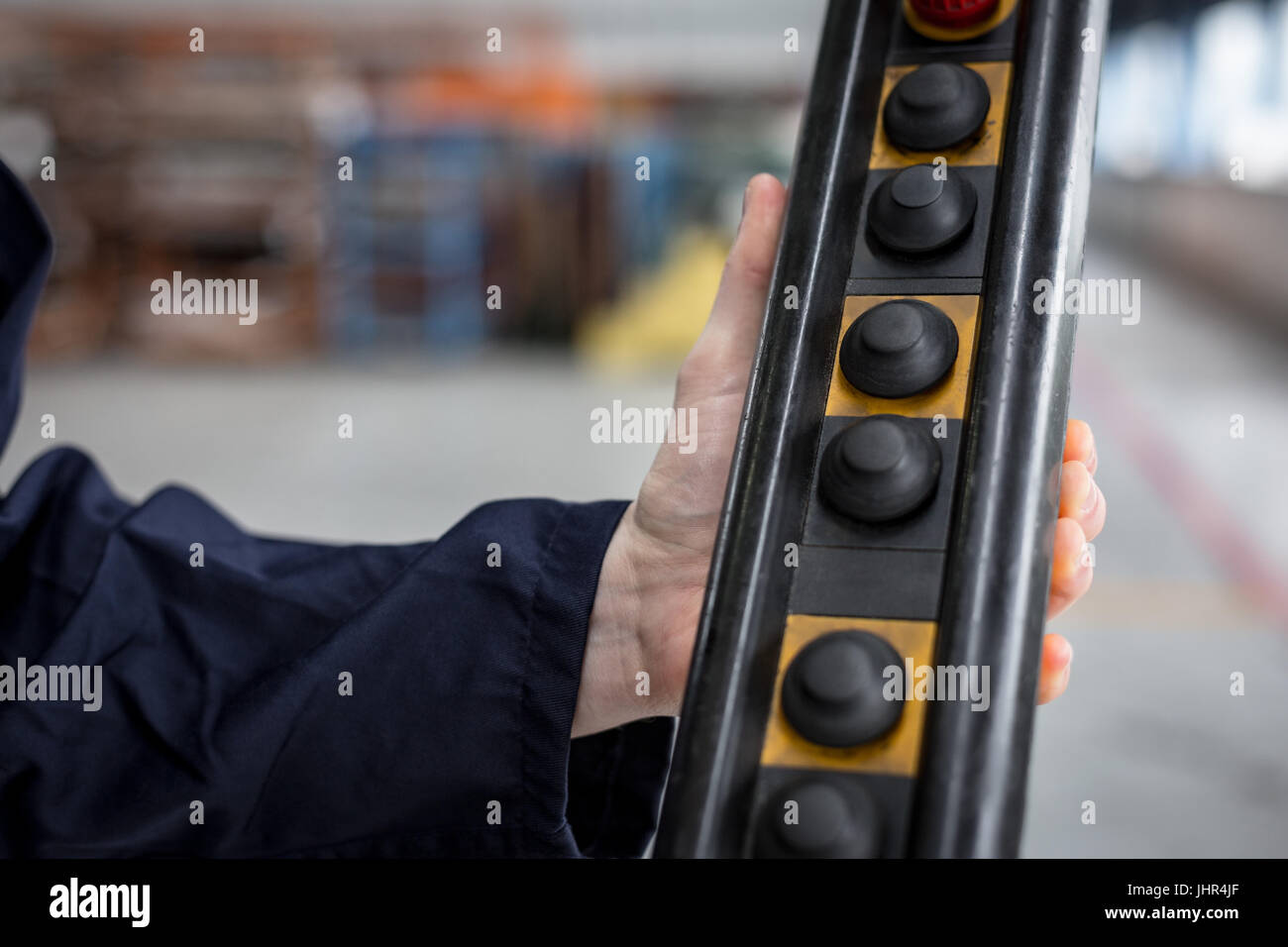 Close-up of maintenance engineer holding a control panel at airlines ...