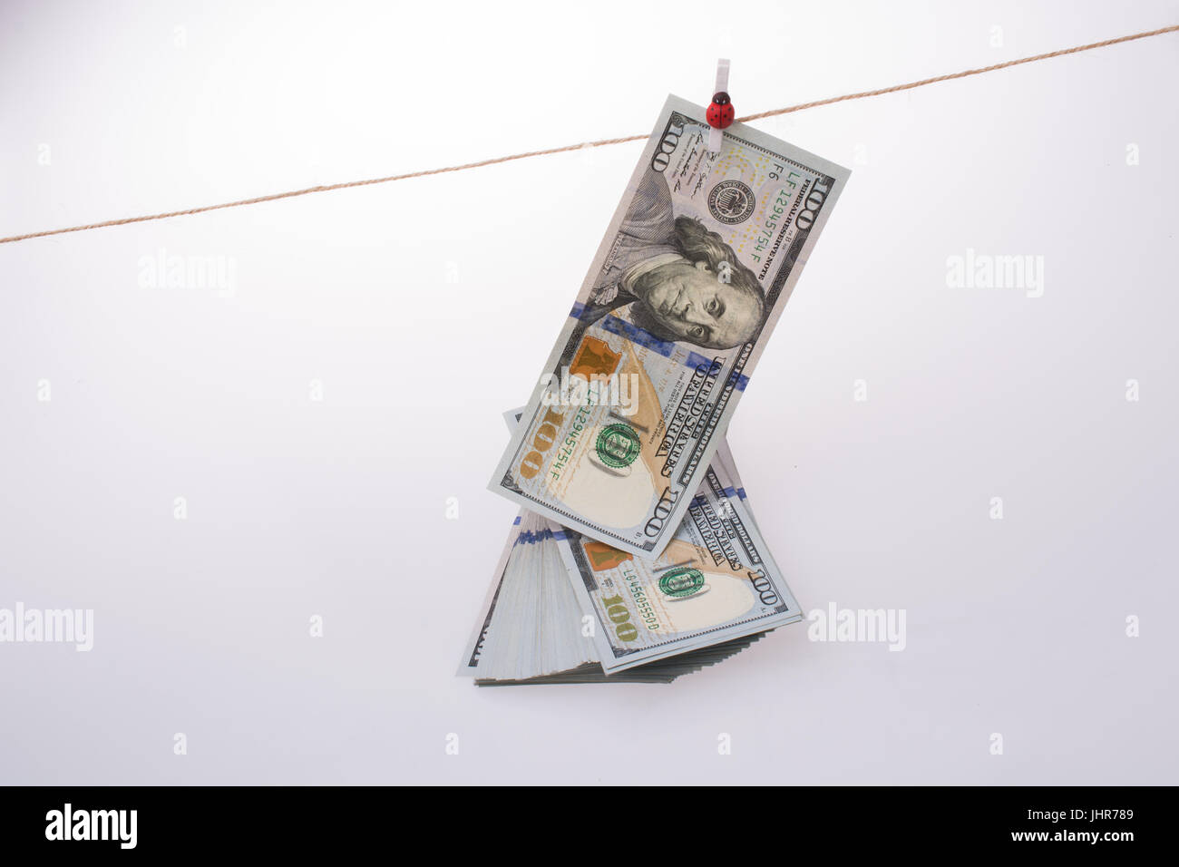 Banknote of US dollar hanging on a linen string Stock Photo - Alamy