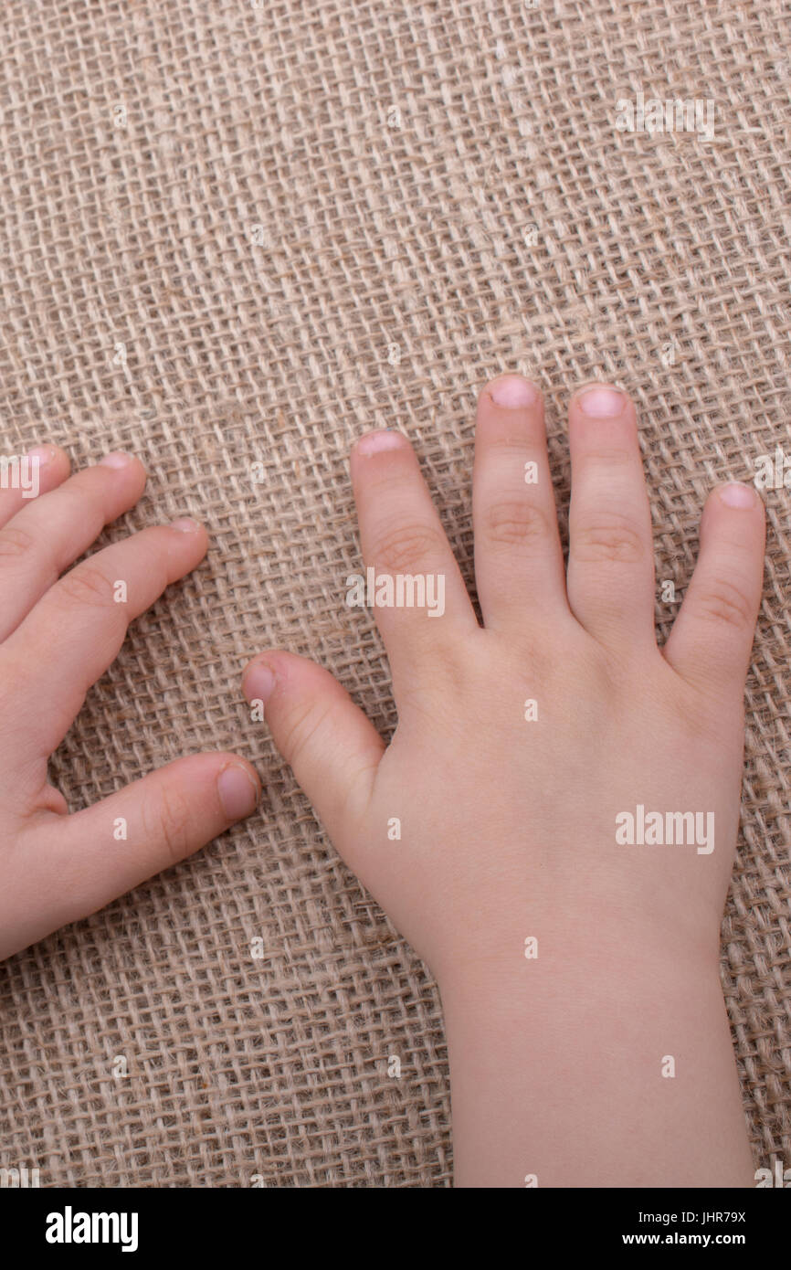 Toddler hand with canvas linen background Stock Photo - Alamy