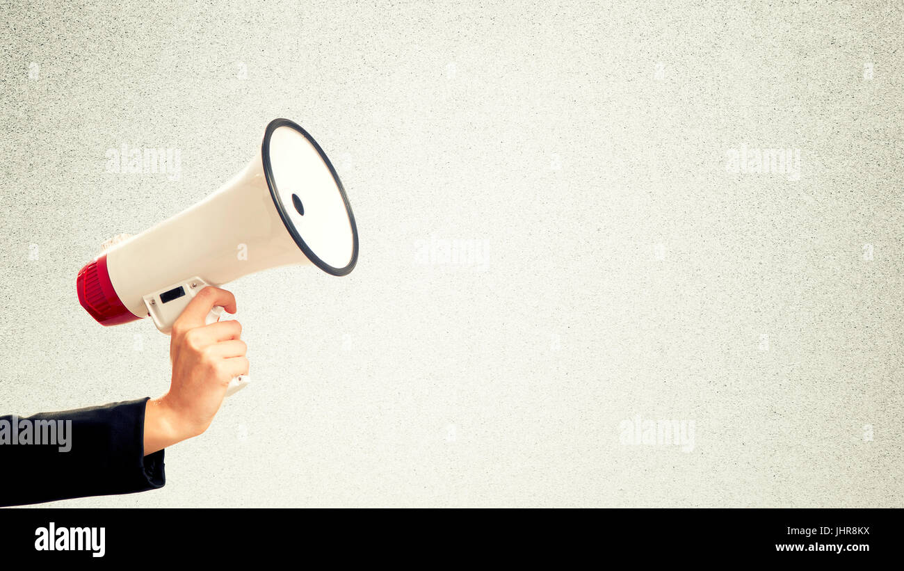 Close up of businessmans hand holding megaphone Stock Photo - Alamy