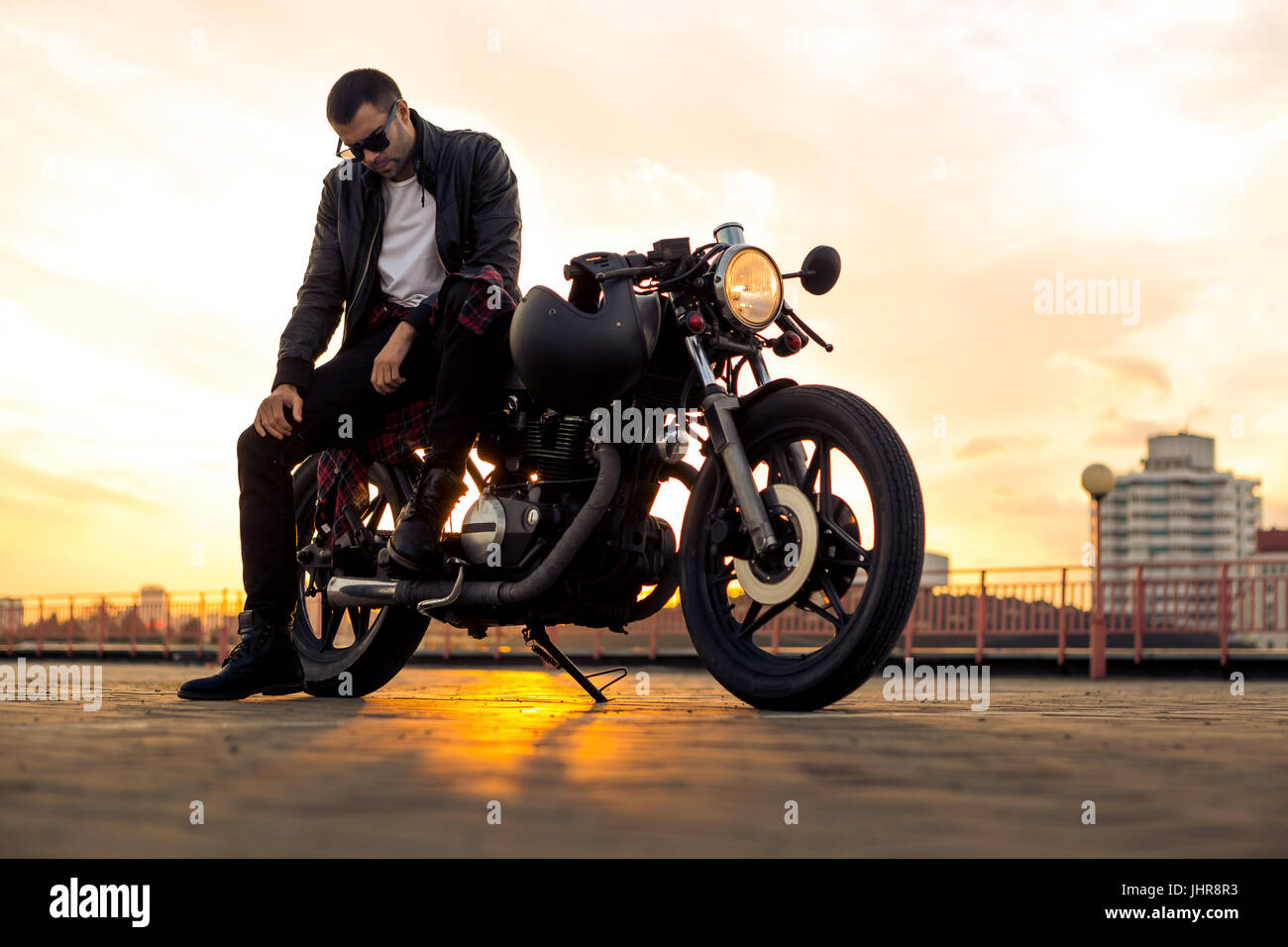 Handsome rider man with beard and mustache in black leather biker ...